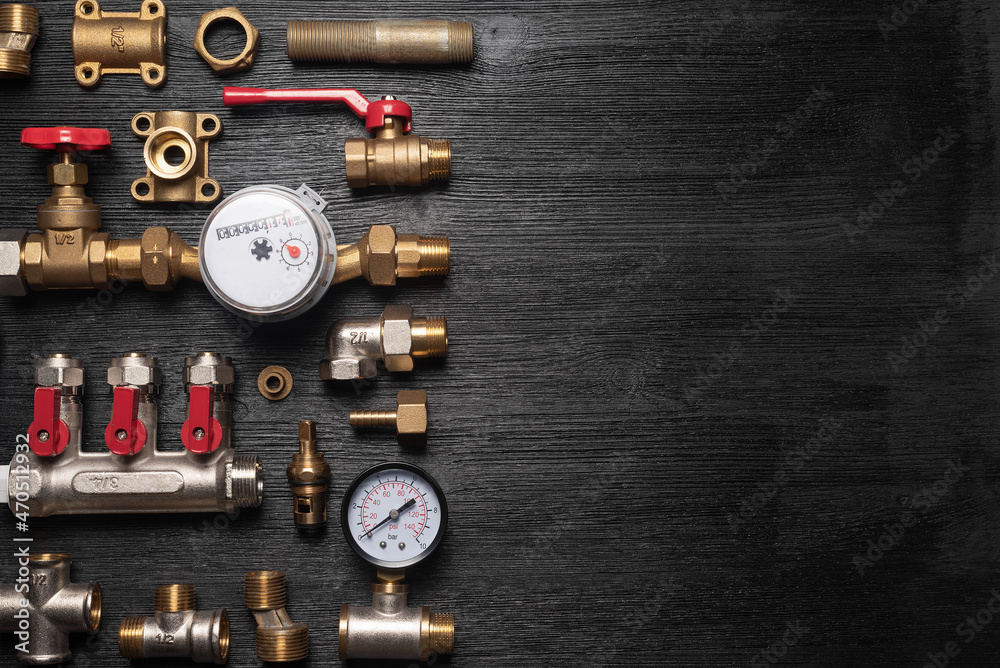 Plumbing equipment and supply on the black workbench background with ...