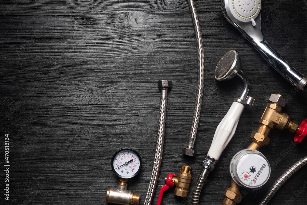 Plumbing equipment and supply on the black workbench background with ...