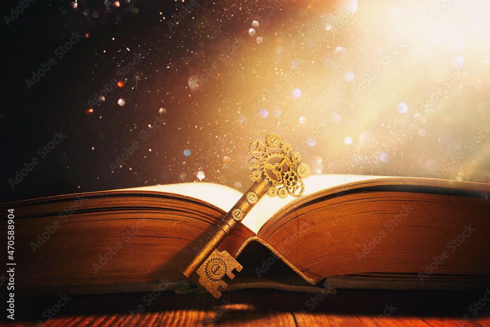 image of open antique book on wooden table with vintage key Stock Photo ...