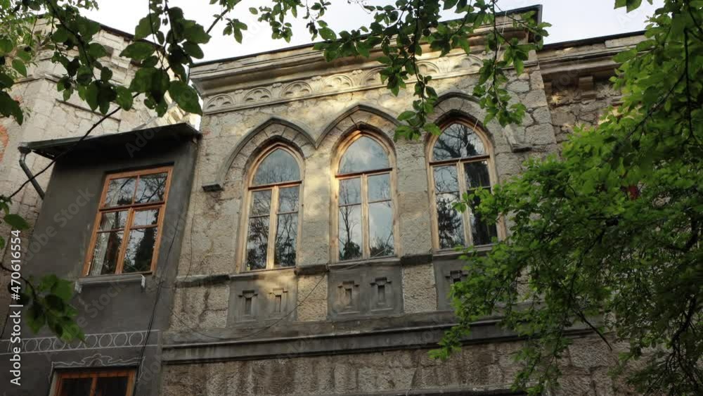 The beautiful vintage mansion with small towers and spires overgrown ...