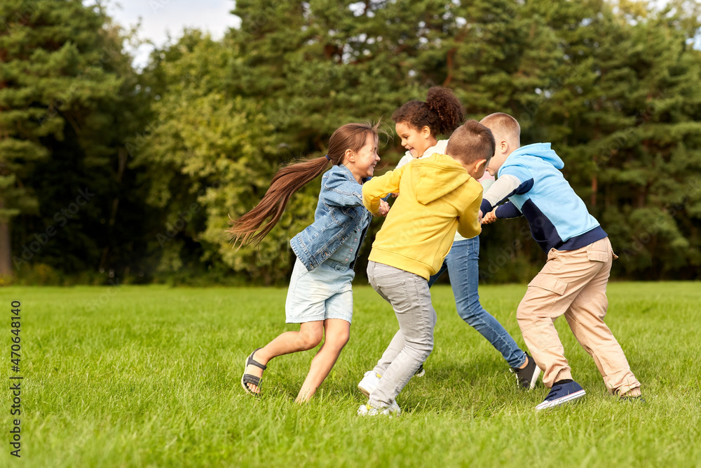 childhood, leisure and people concept - group of happy kids playing ...