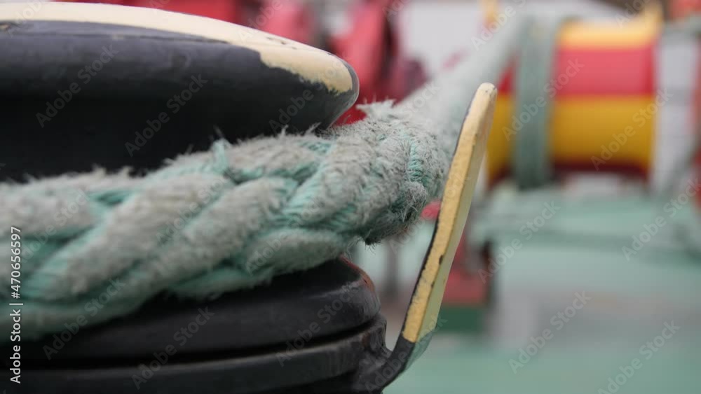 Large nylon rope rolling and moving from a bollard to a windass ...