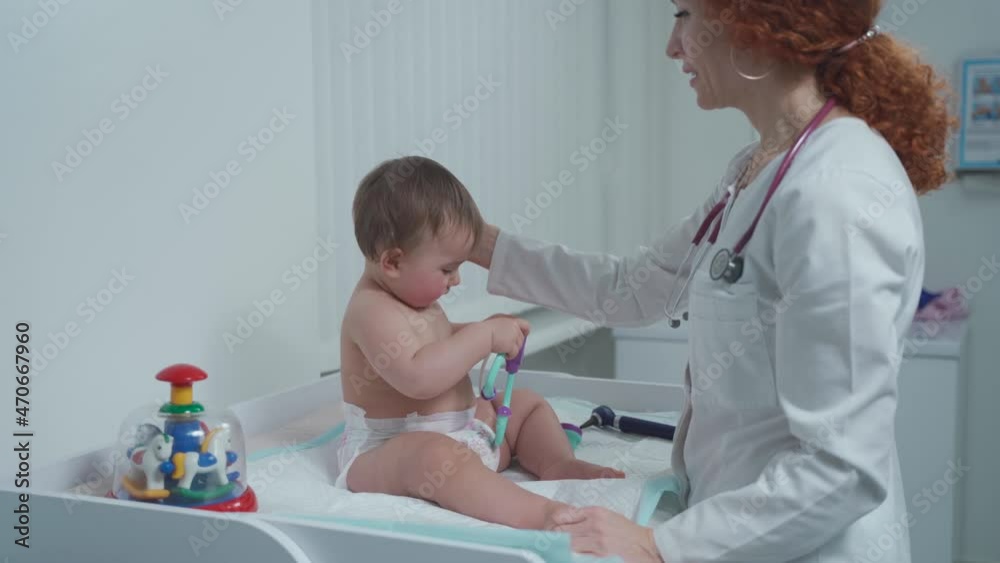 Little girl at doctor for checkup. Doctor pediatrician and baby patient ...