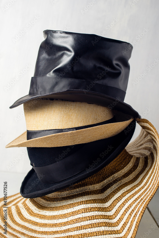 Stack of hats, various type of hats and a red book isolated on white ...