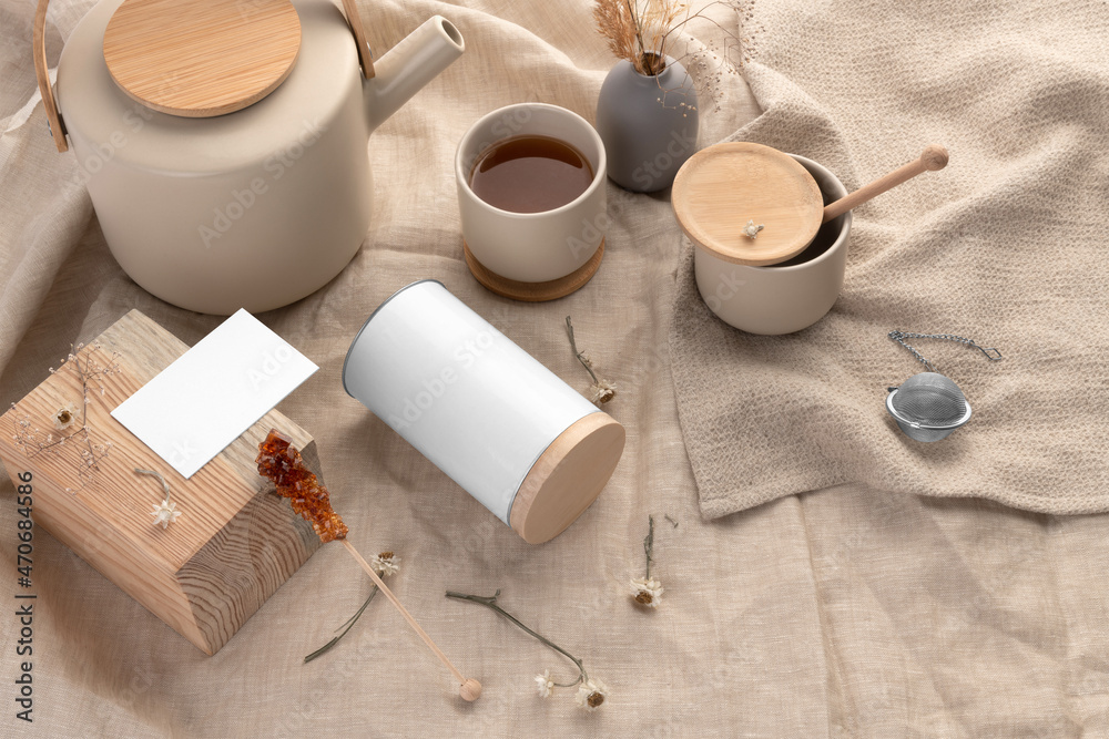 Blank tea container, with pot, teacup, business card, flowers on a ...