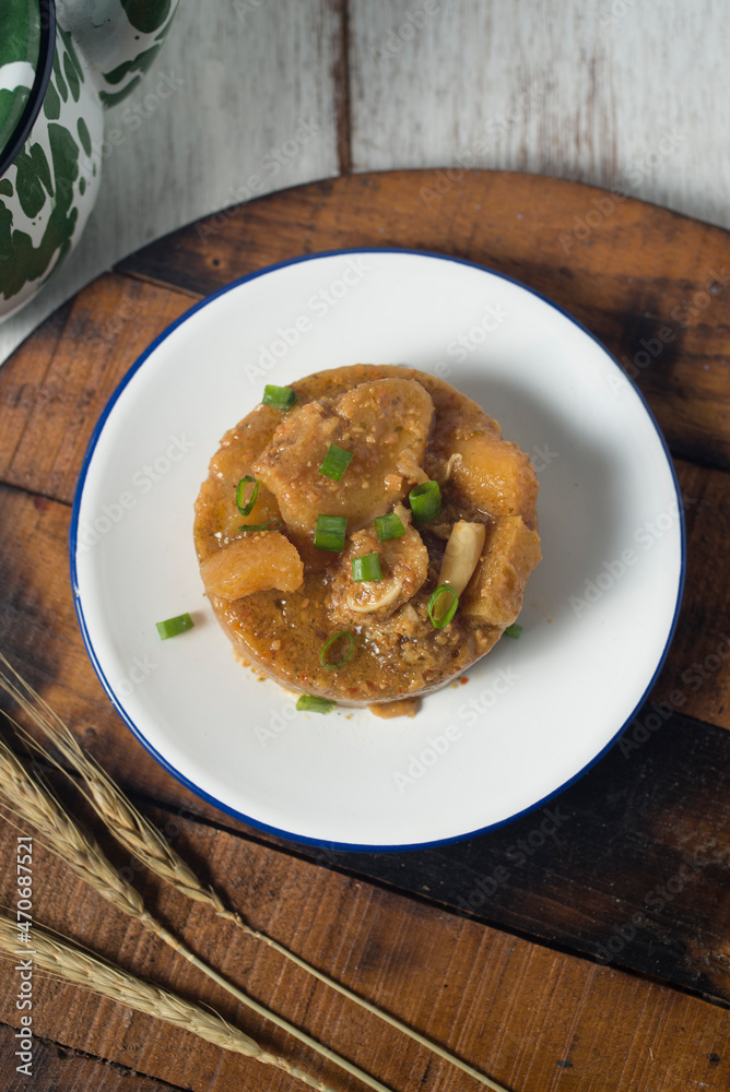 Cow skin meat cooked with spicy peanut sauce with onion leaves as ...