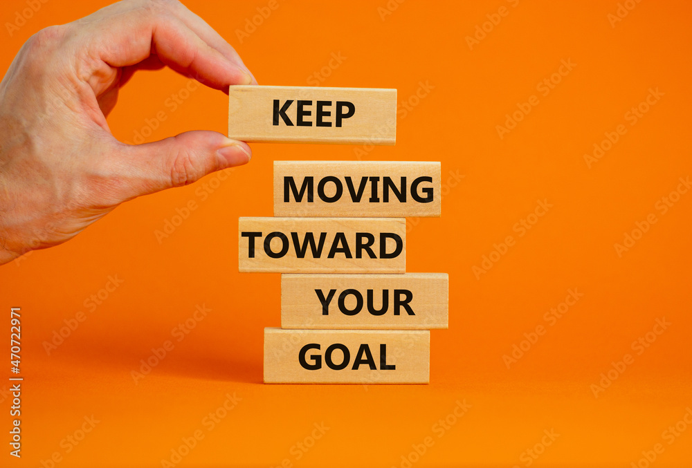 Keep moving toward your goal symbol. Wooden blocks with words Keep ...