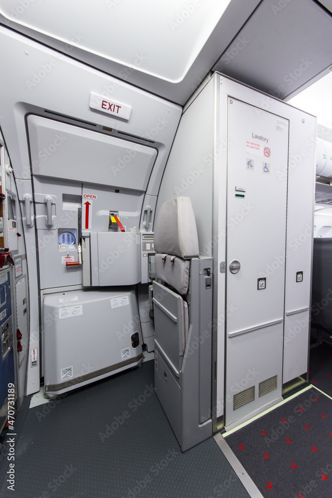 Fordward section of an Airbus A320 cabin with exit door and a toilette ...