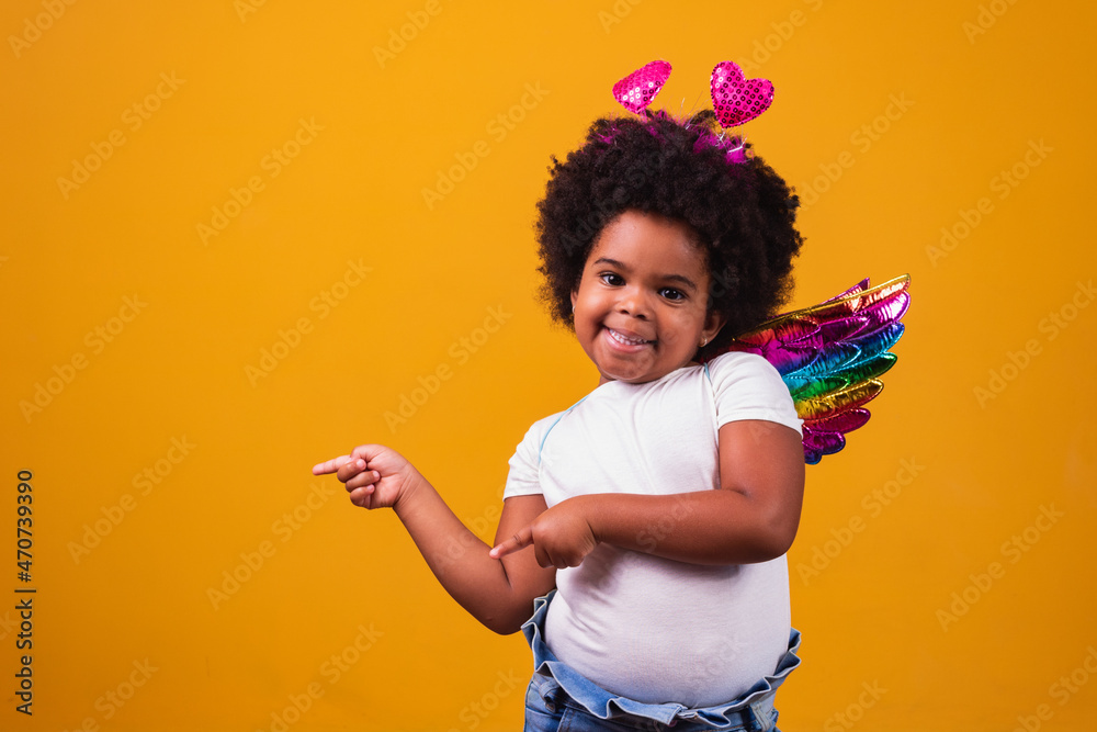 adorable afro girl dressed in colorful outfit on yellow background ...