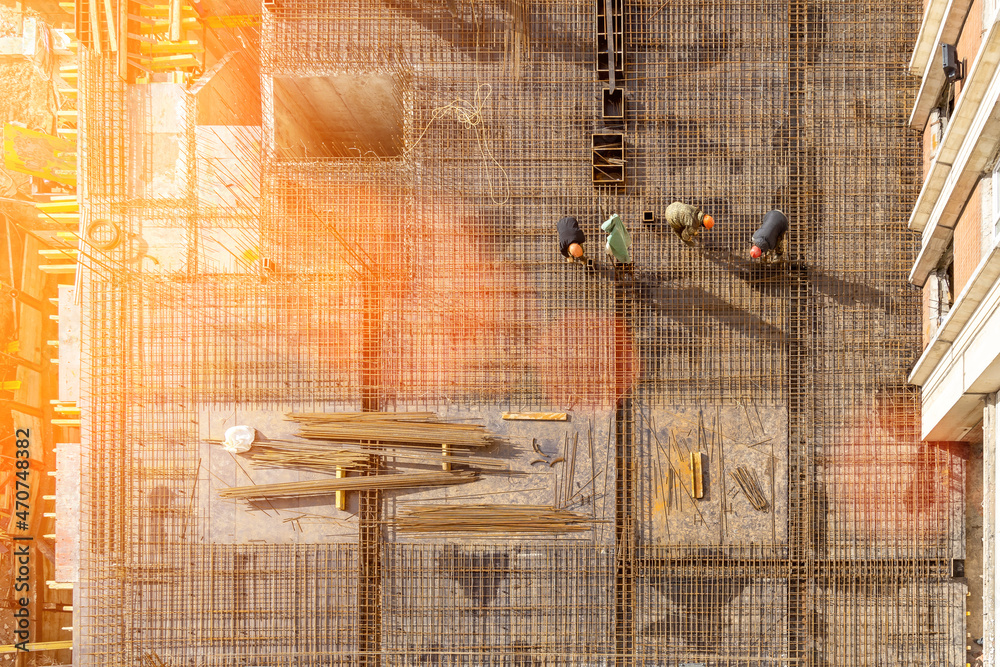Concrete work at the construction site. Construction workers wearing ...