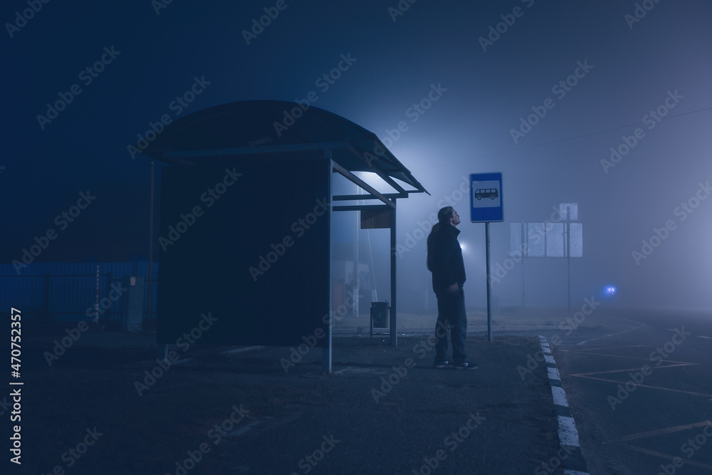 Alone sad man waiting for bus at bus stop Stock Photo | Adobe Stock