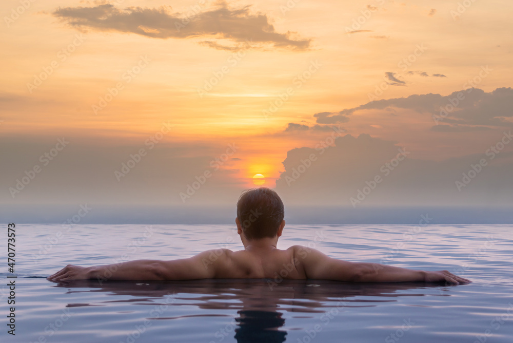 Man Relaxing In Infinity Swimming Pool Water. Beautiful Happy Healthy ...