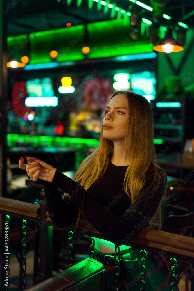Young attractive woman with long blond hair in a nightclub restaurant ...