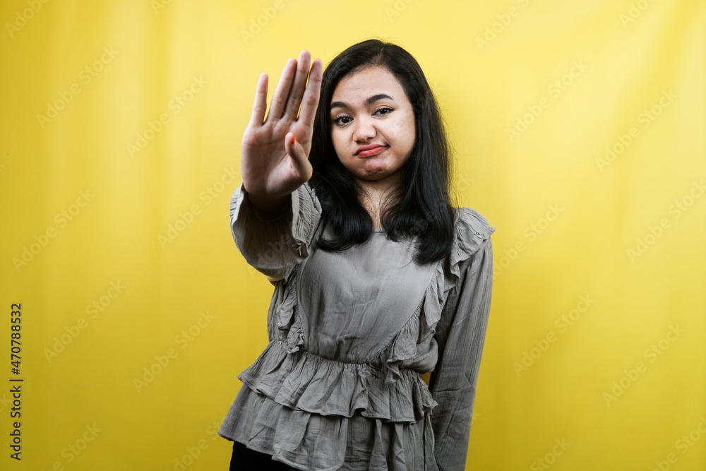 Beautiful young woman serious, with stop sign hand, prohibition sign ...
