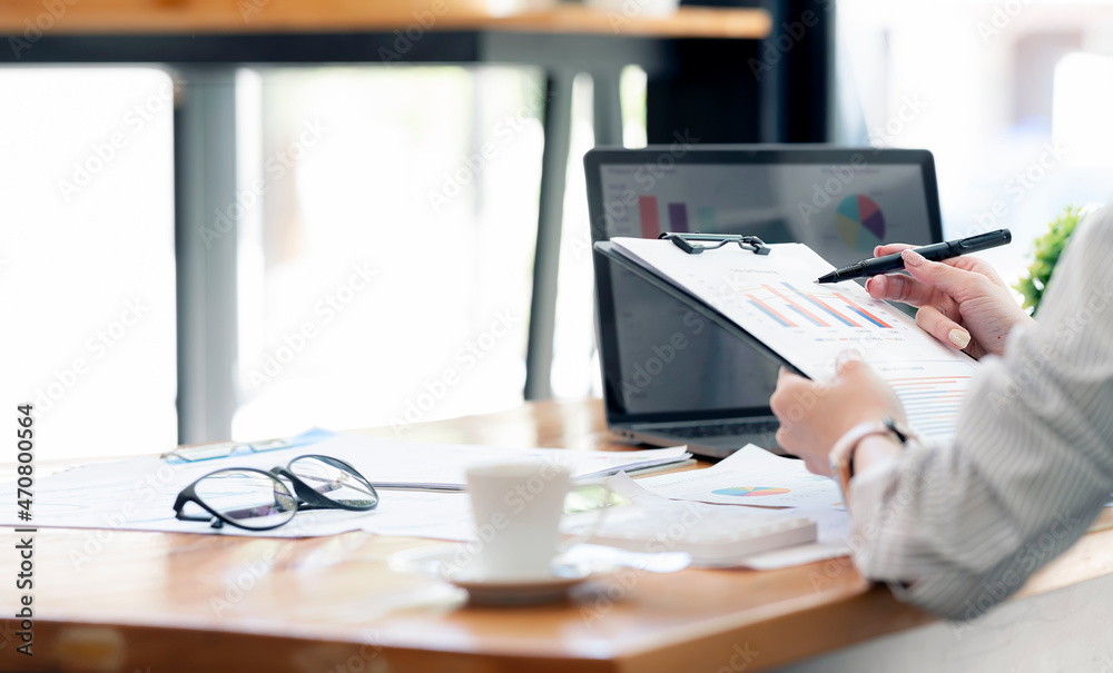 woman hand working on graph chart, analyzing and calculating graph and ...