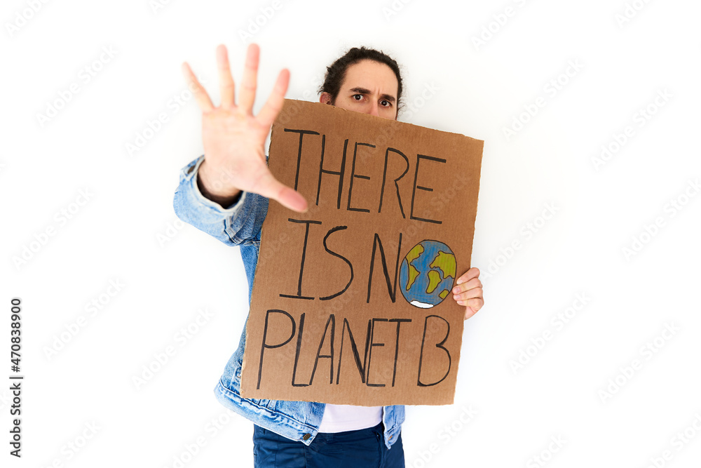 Fight climate change concept. Serious young man holding cardboard ...