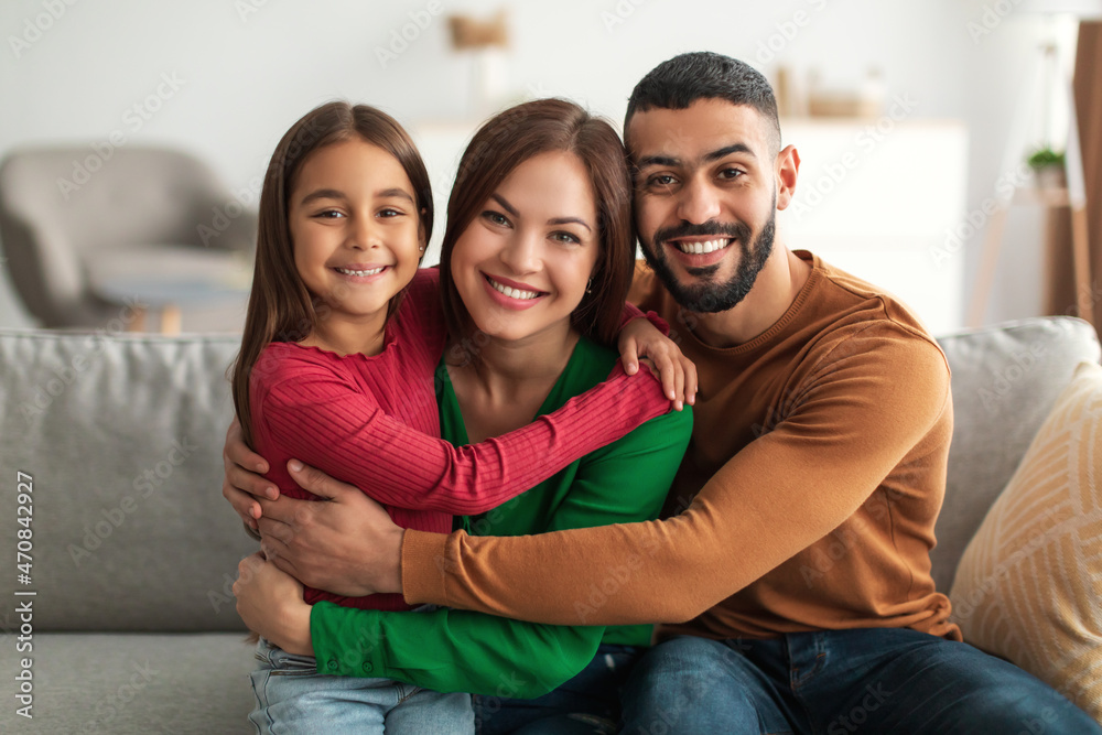 Foto de Portrait of cheerful happy Arab family smiling at home do Stock ...