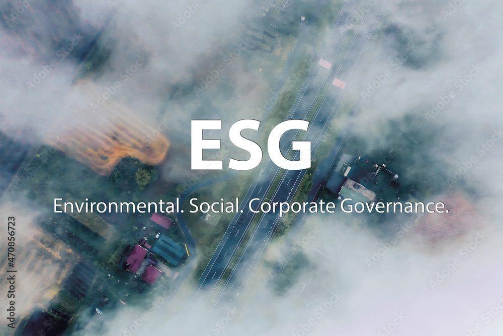 ESG inscription on industrial aerial landscape with clouds. ESG environmental conservation ...