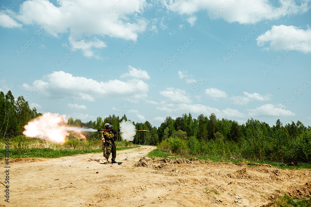 a soldier shoots an RPG. training shooting from a rocket launcher at a ...