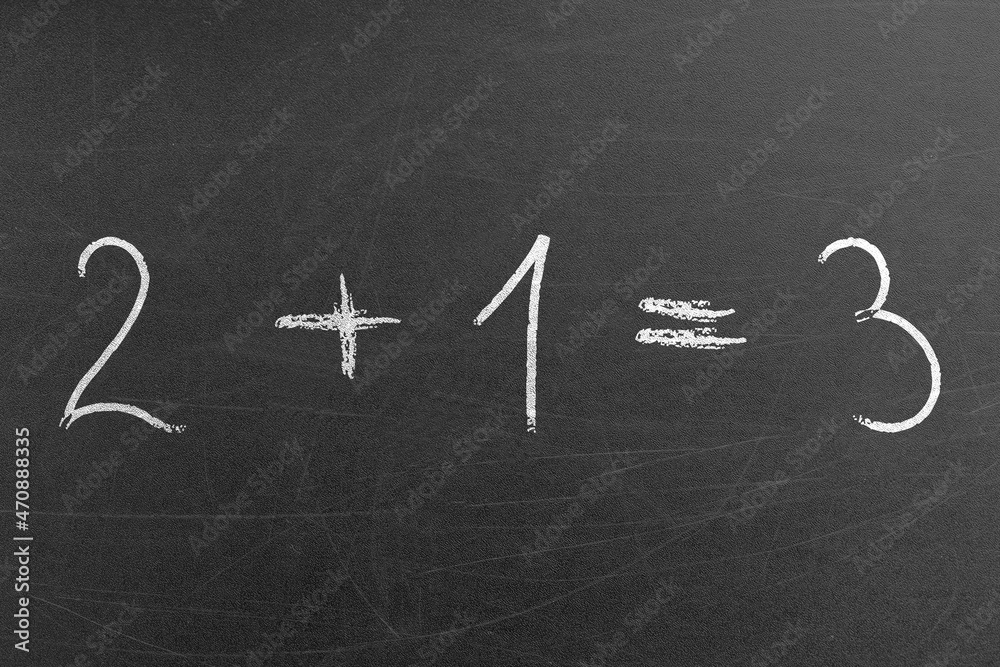 Easy school math equation 2 plus 1 is 3 written on a chalkboard by a ...