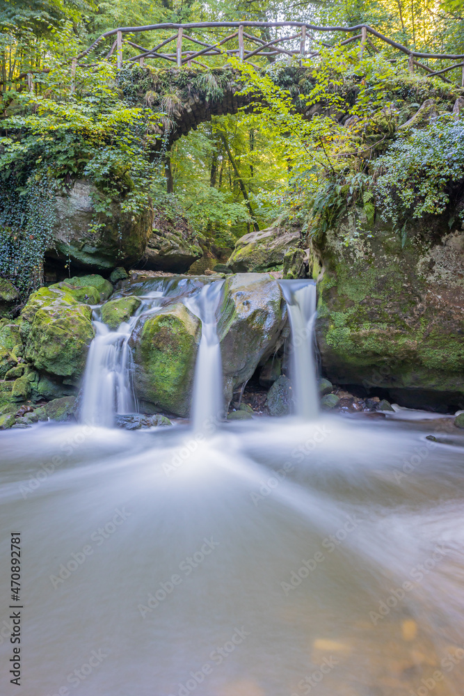 Stone bridge over the Black Ernz river, Schiessentümpel waterfall ...