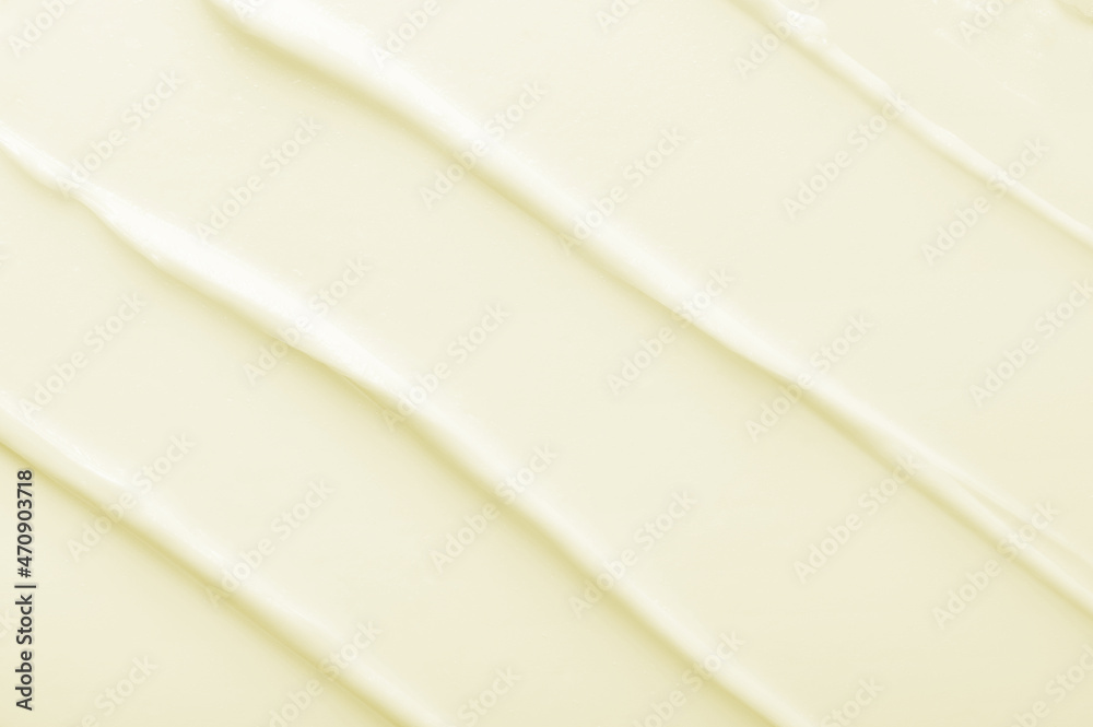 Light yellow body and facial cream with diagonal smear strips as ...
