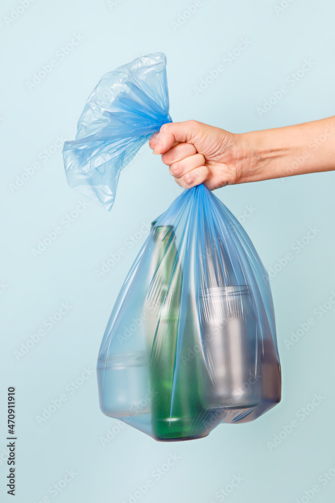 Woman hand holds garbage bag with glass garbage. Eco friendly concept ...