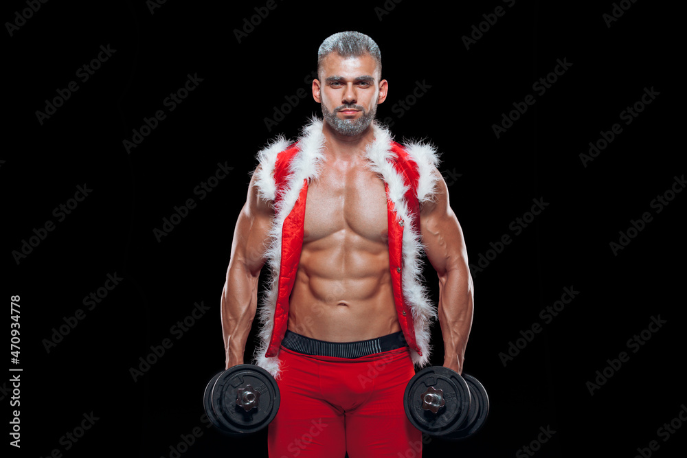 Sexy Santa Claus. Bodybuilder young handsome santa clause smile holds a ...