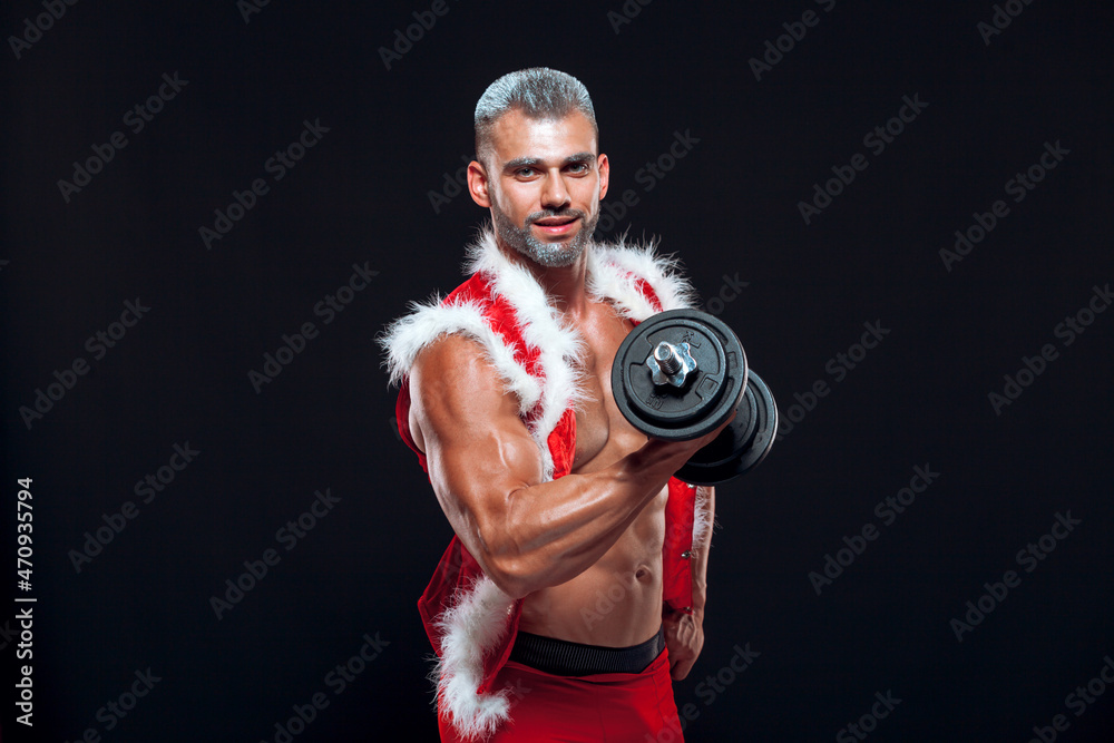 Sexy Santa Claus. Bodybuilder young handsome santa clause smile holds a ...