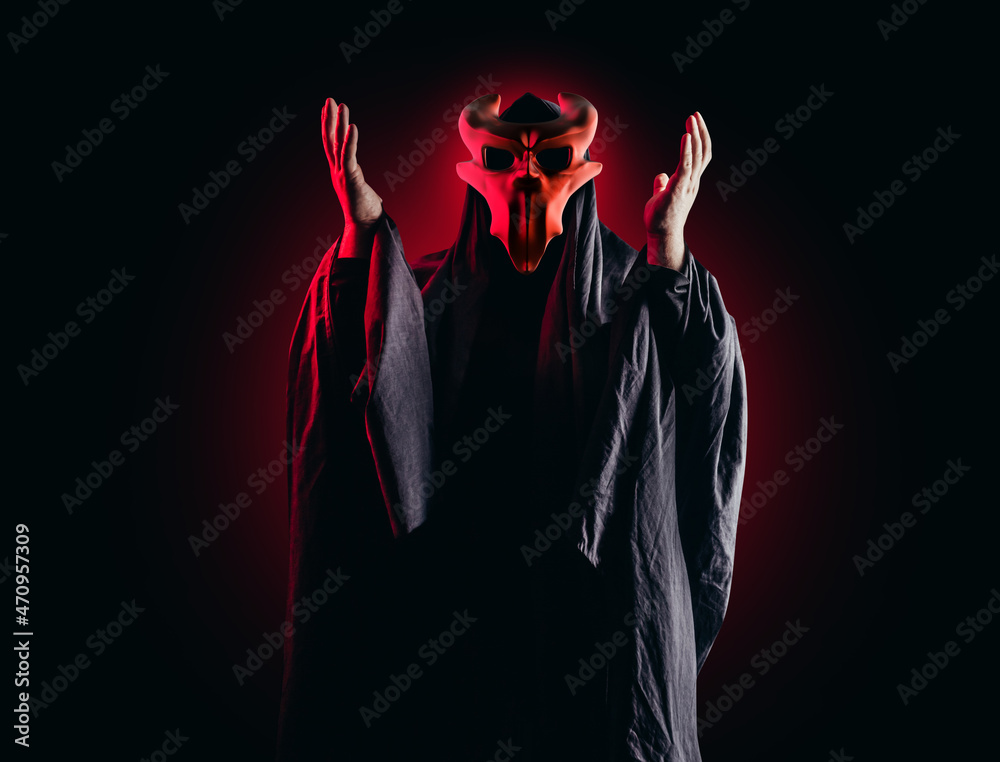 Scary horror occult sectarian priest in black hood and metal mask on ...