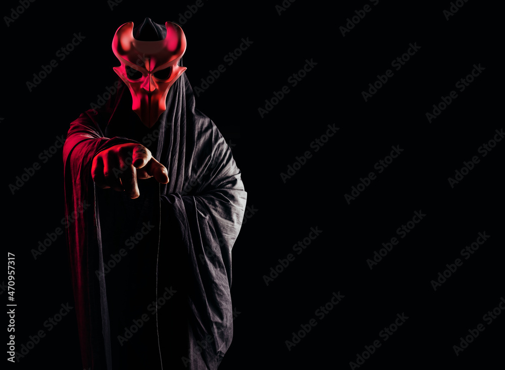 Scary horror occult sectarian priest in black hood and metal mask on ...