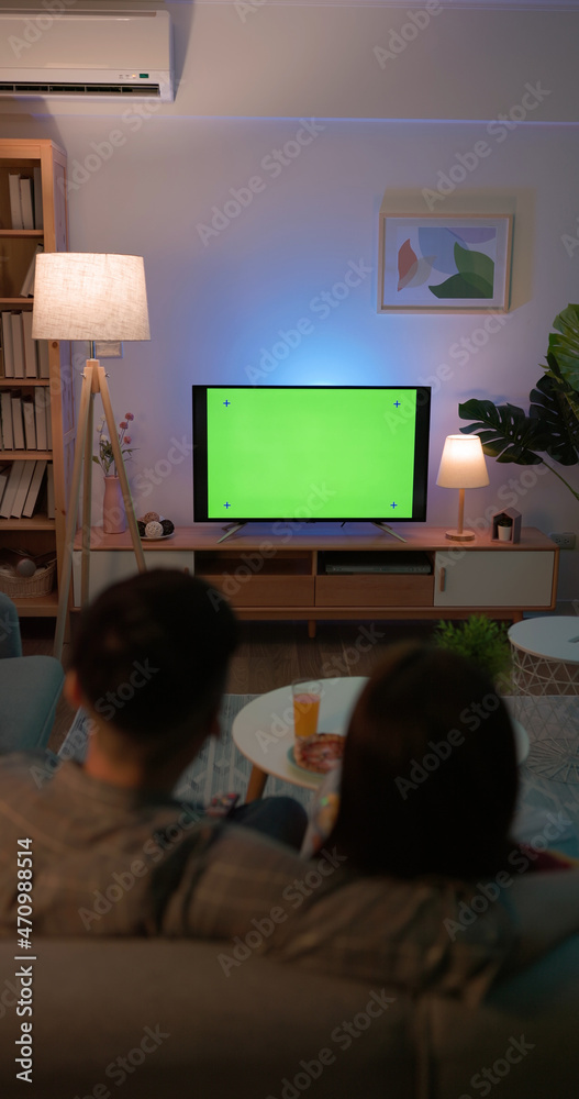 couple watch green screen TV Stock Photo | Adobe Stock