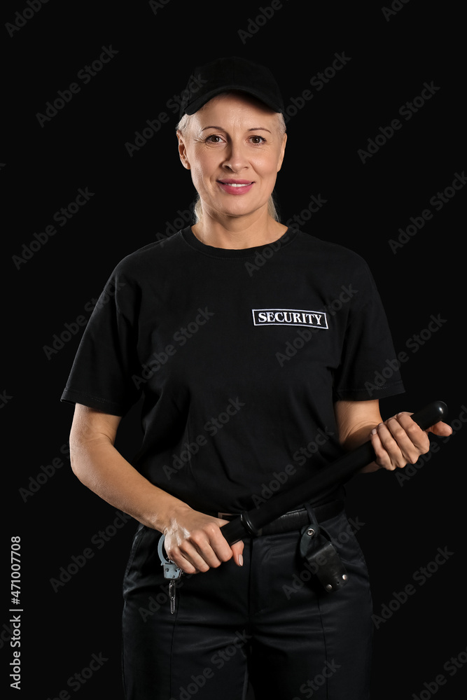 Female security guard with baton on dark background Stock Photo | Adobe ...