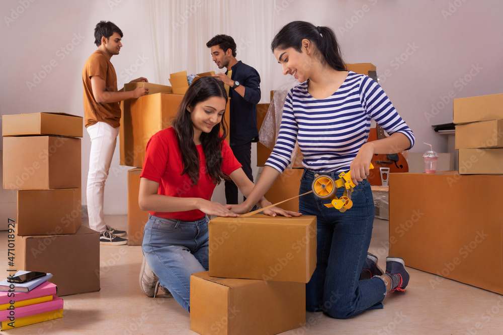 Girls packing cardboard boxes and the boys checking carton box Stock ...