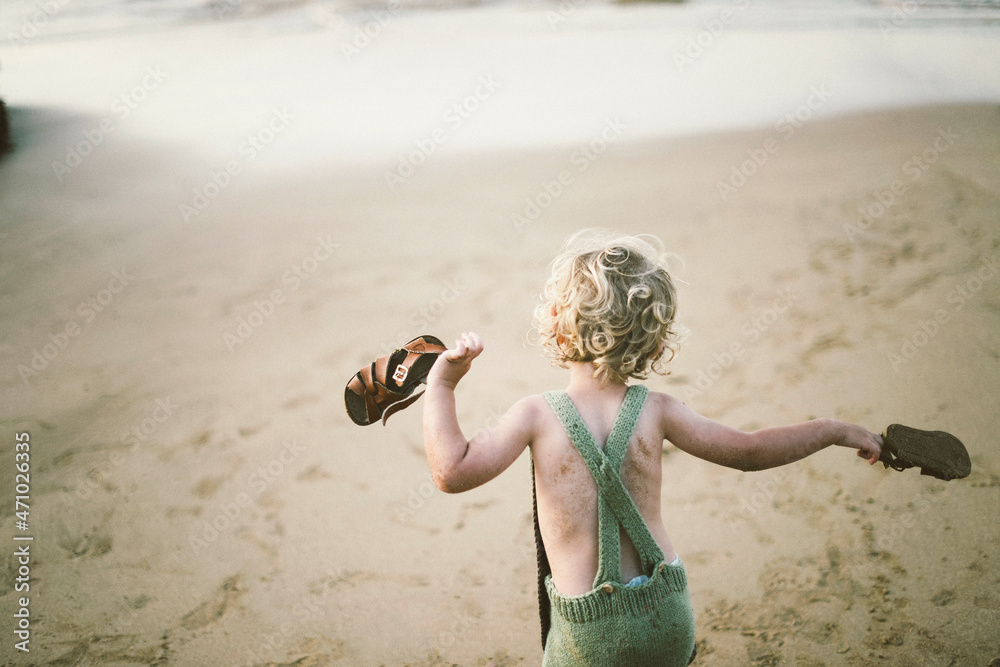Full Length Of Shirtless Boy On Sand At Beach Stock Photo | Adobe Stock