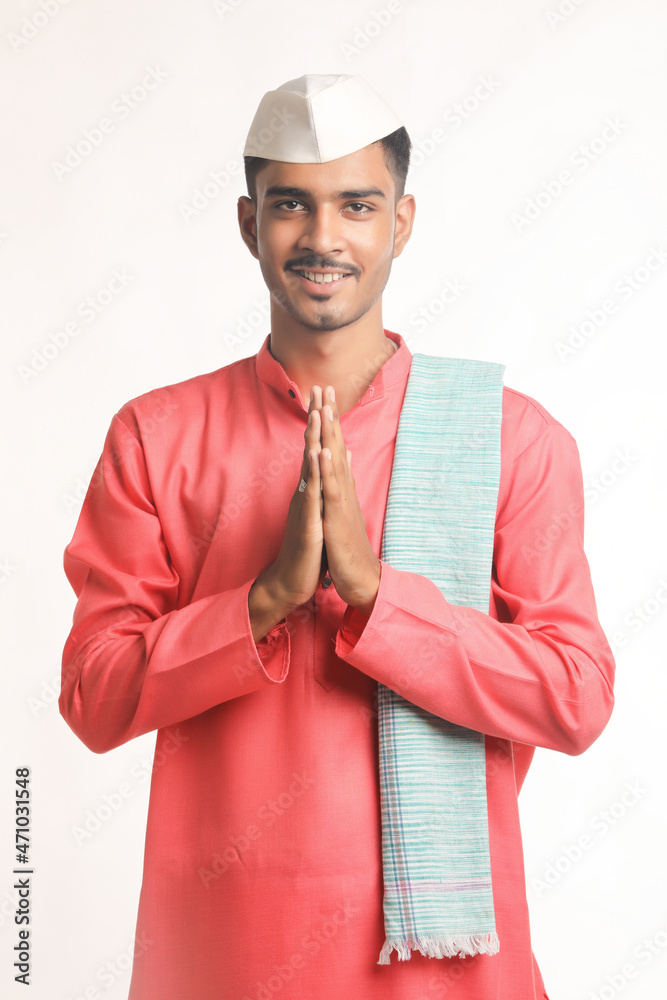 young indian man in traditional wear and showing expression on white ...