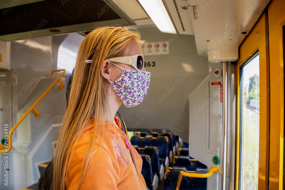 Teenage girl wearing face mask inside for the train. Sydney trains ...