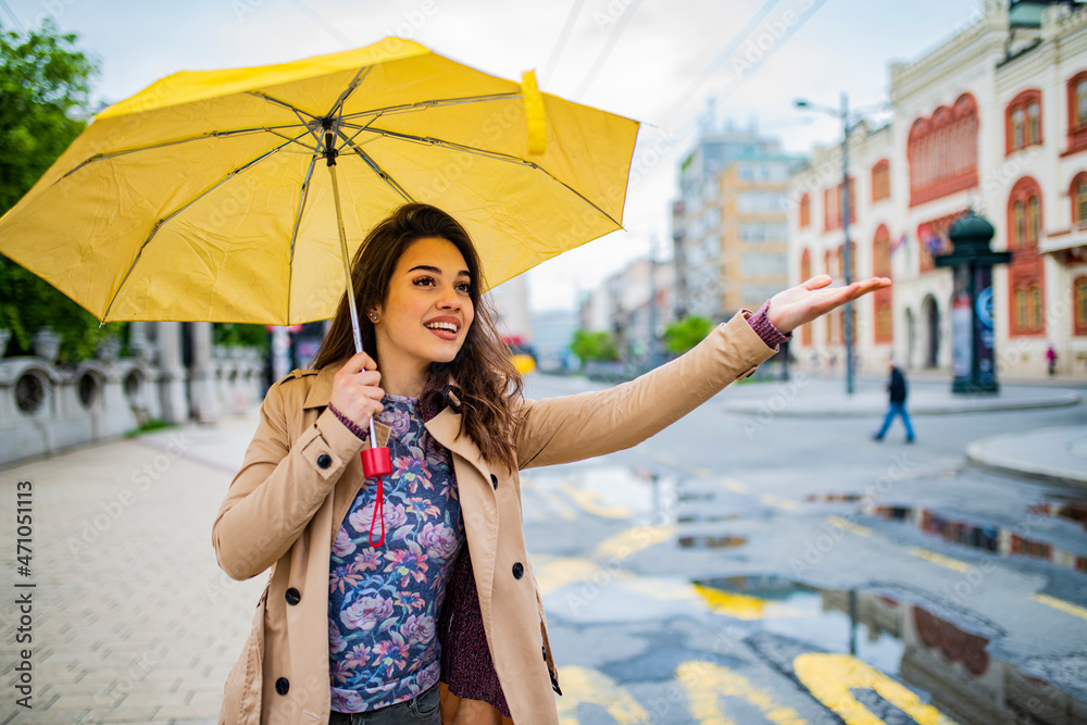 Rainy day asian woman wearing a raincoat outdoors. She is happy.She ...
