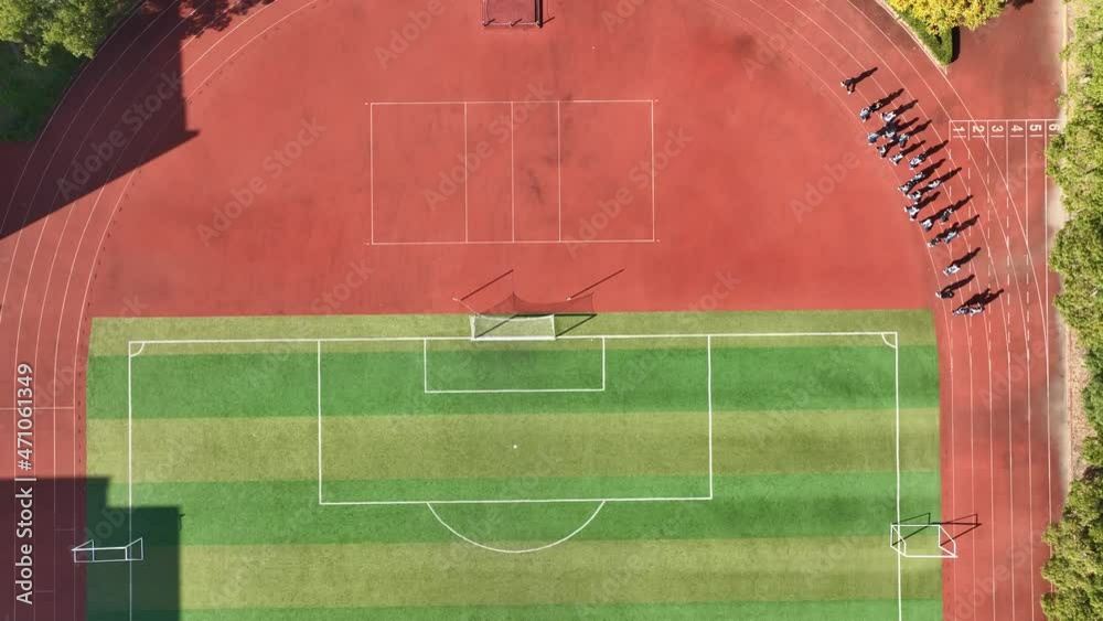 Drone aerial view of people running at the football stadium Shanghai ...