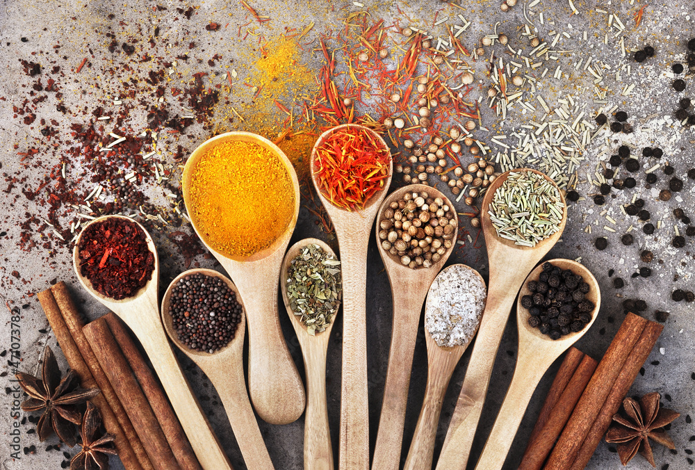 Colorful mix of herb and spice varieties: curry, coriander, turmeric ...
