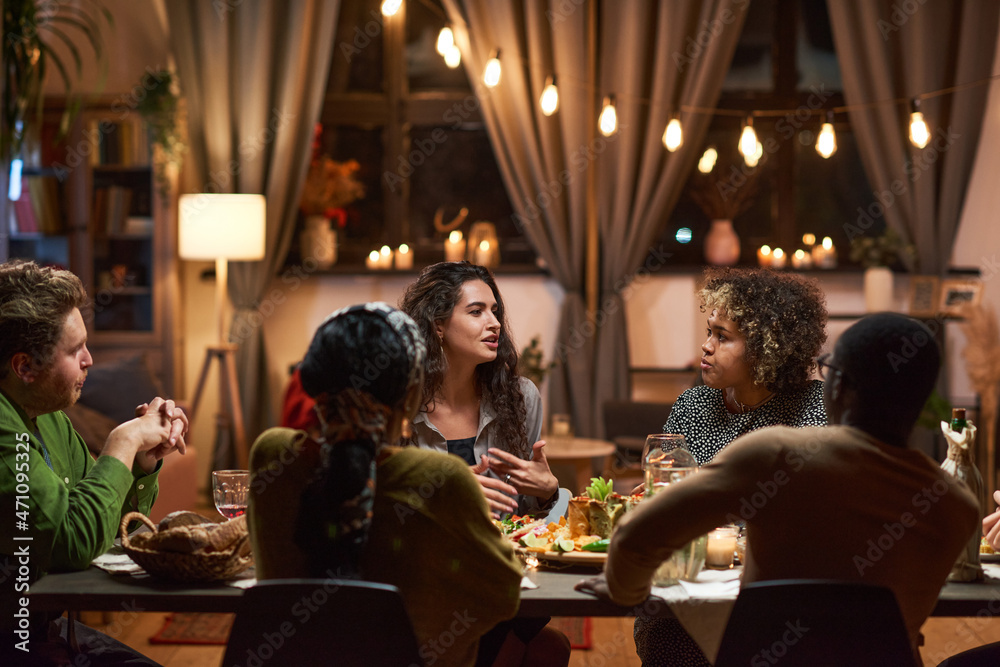 Group of friends talking to each other at dining table during a meeting ...