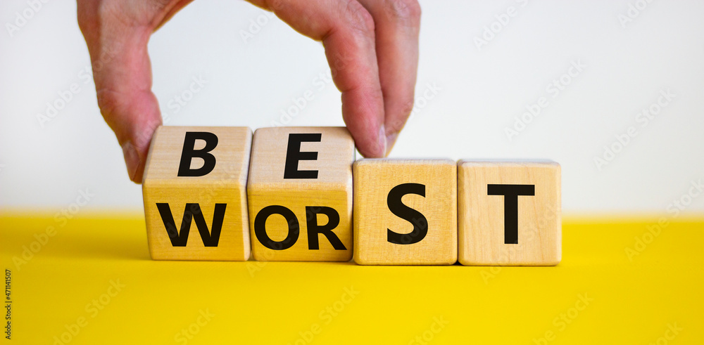 Best or worst symbol. Businessman turns wooden cubes and changes the ...