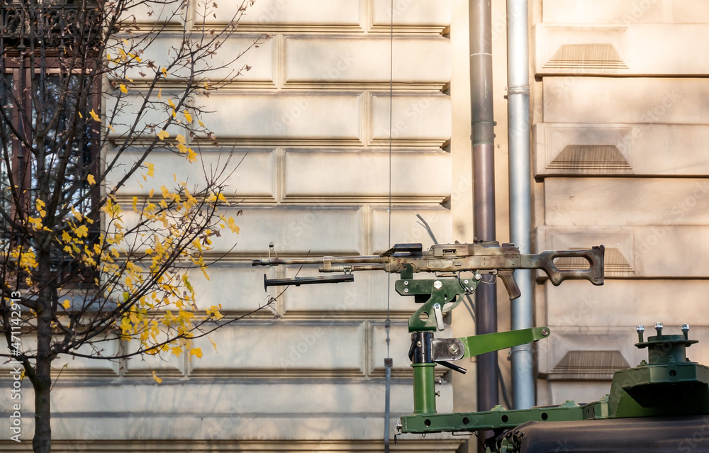 One single simple machine gun on top of a military vehicle in the city ...