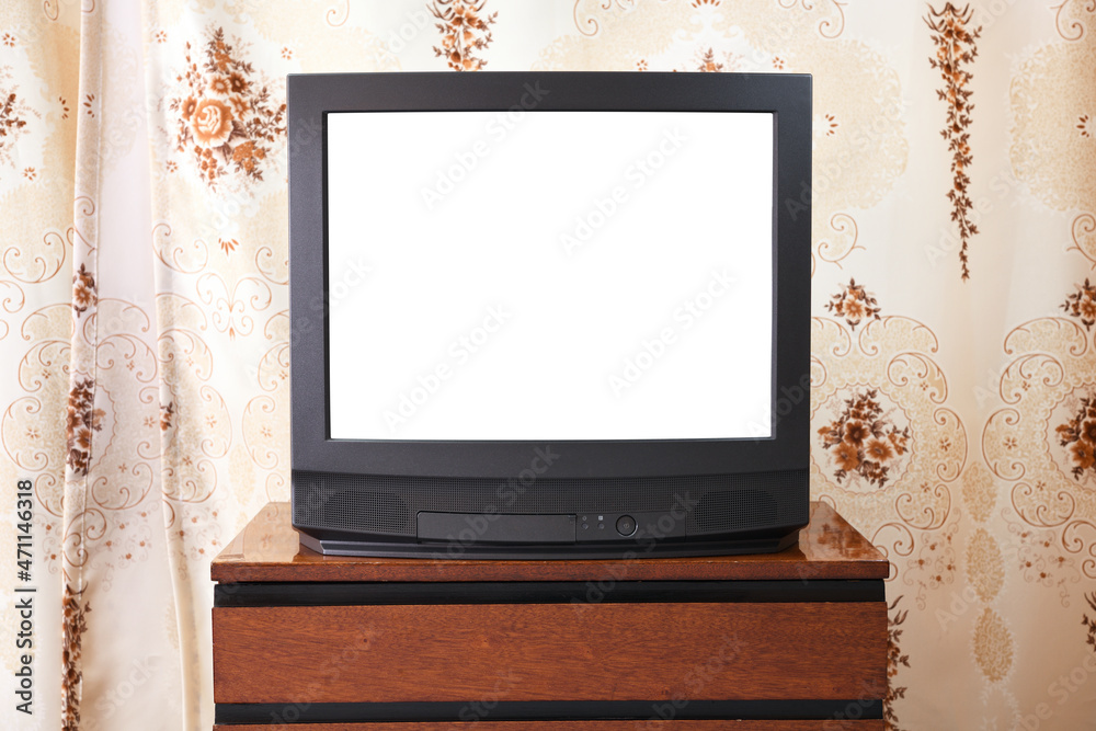 Old TV with white screen on a vintage wooden cabinet, old design in an ...