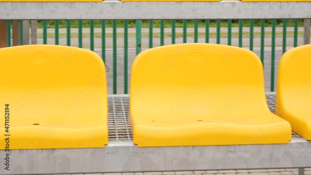 Empty vacant stadium stands, chairs, plastic yellow arena spectator ...