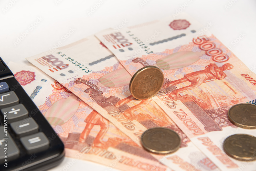 Russian money and (5000 rubles) and calculator. Calculation of income ...