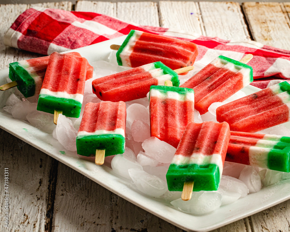 Tray of gourmet ice pops that look like slices of watermelon on a ...