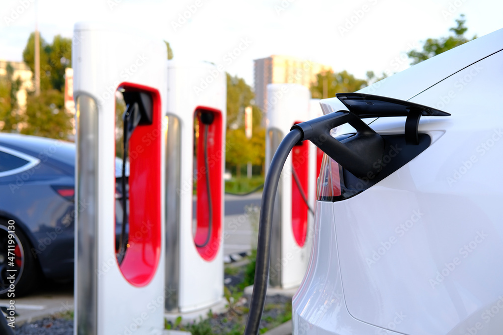 Tesla light electric cars replenish battery at charging station ...