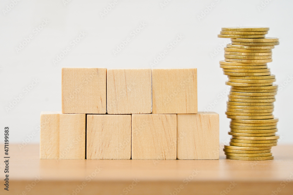 pile of blank wooden cube and stack of golden coins on wood desk, for ...