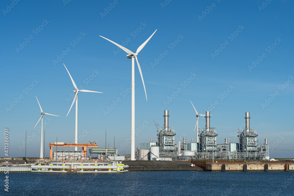 Modern multi-fuel power station and wind turbines at a seaport. Stock ...
